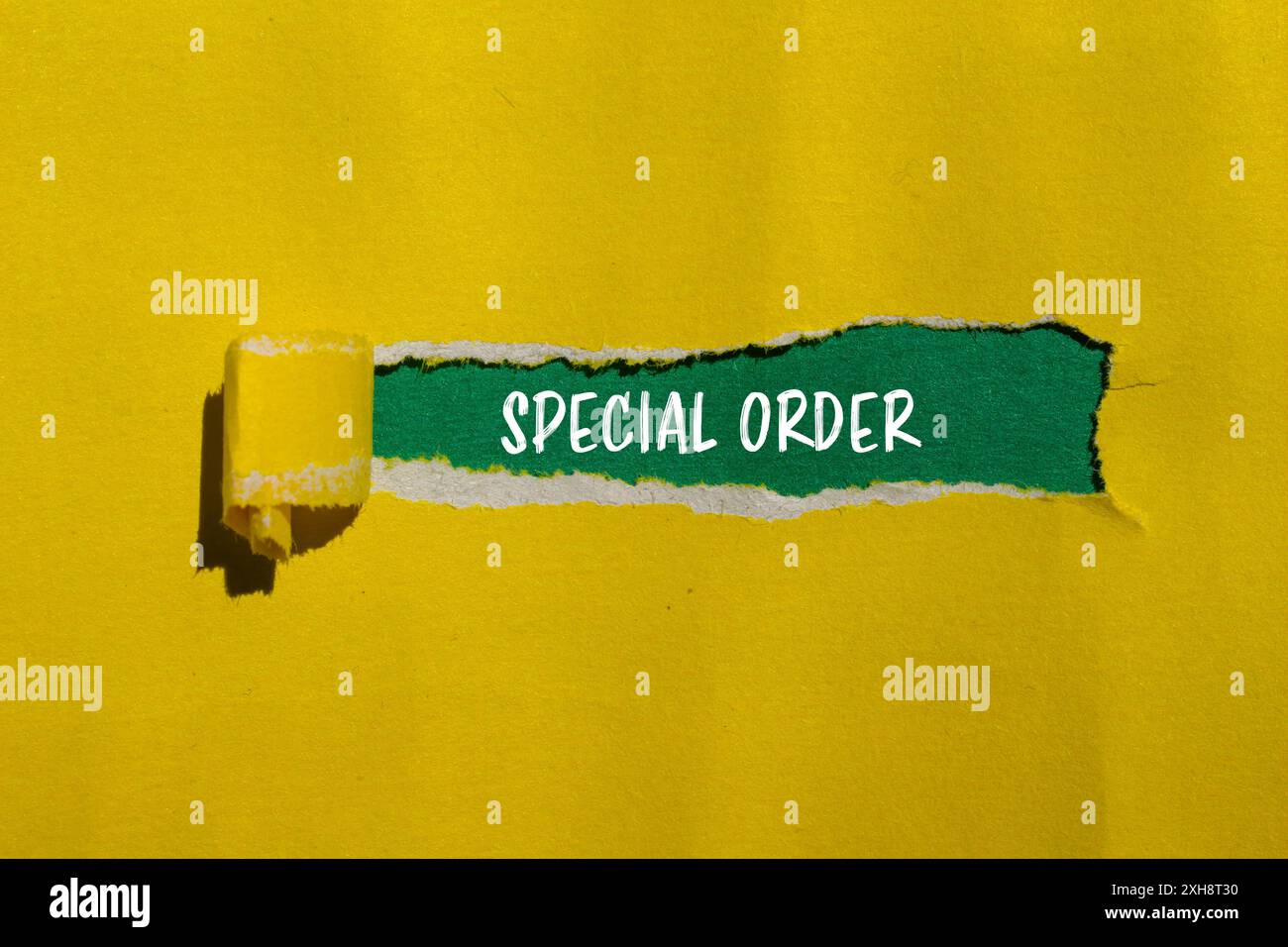 Special order message written on ripped yellow paper with green ...