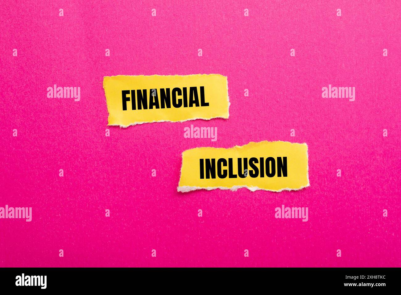 Financial inclusion message written on ripped yellow paper pieces with ...