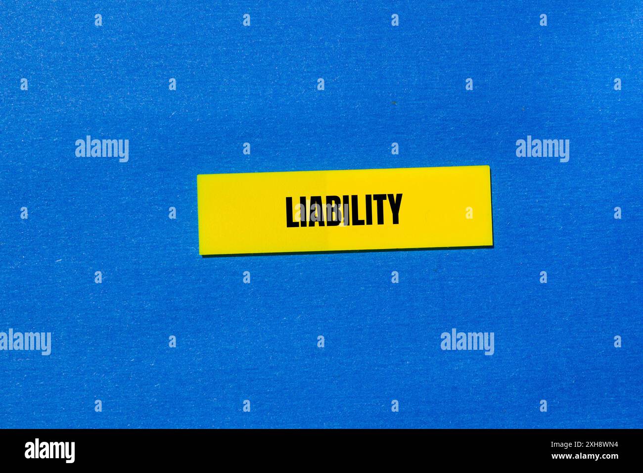 Liability message written on yellow paper with blue background ...