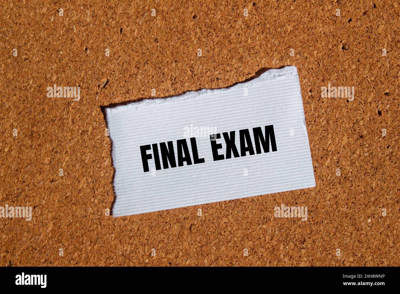 Final exam words written on ripped white paper with brown background ...