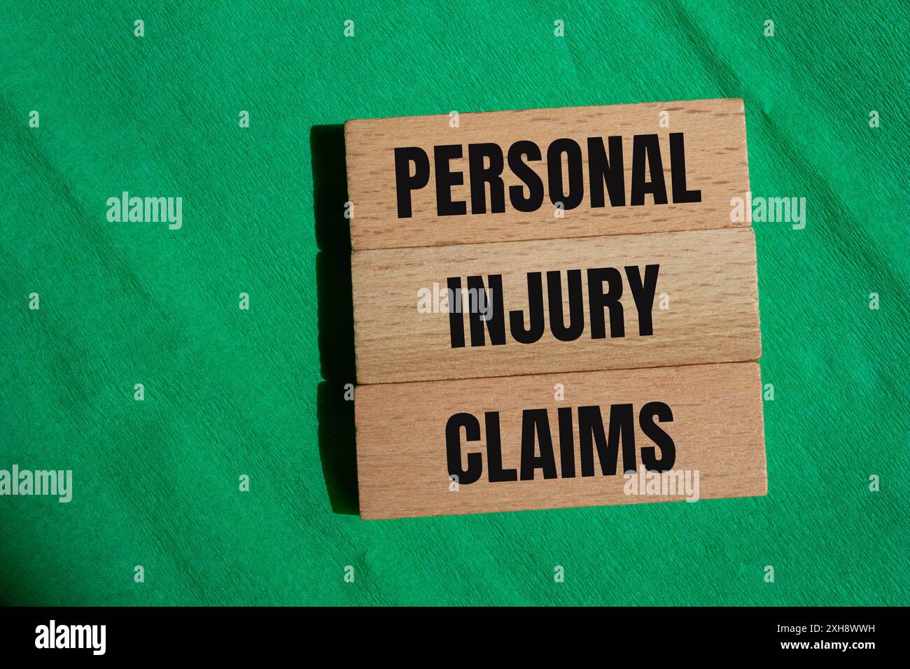Personal injury claims words written on wooden blocks with green ...