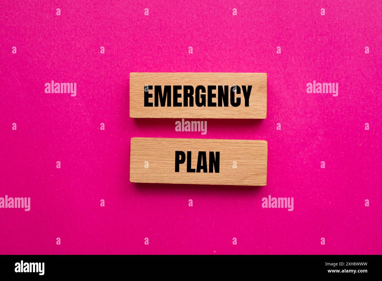 Emergency plan message written on wooden blcoks with pink background ...