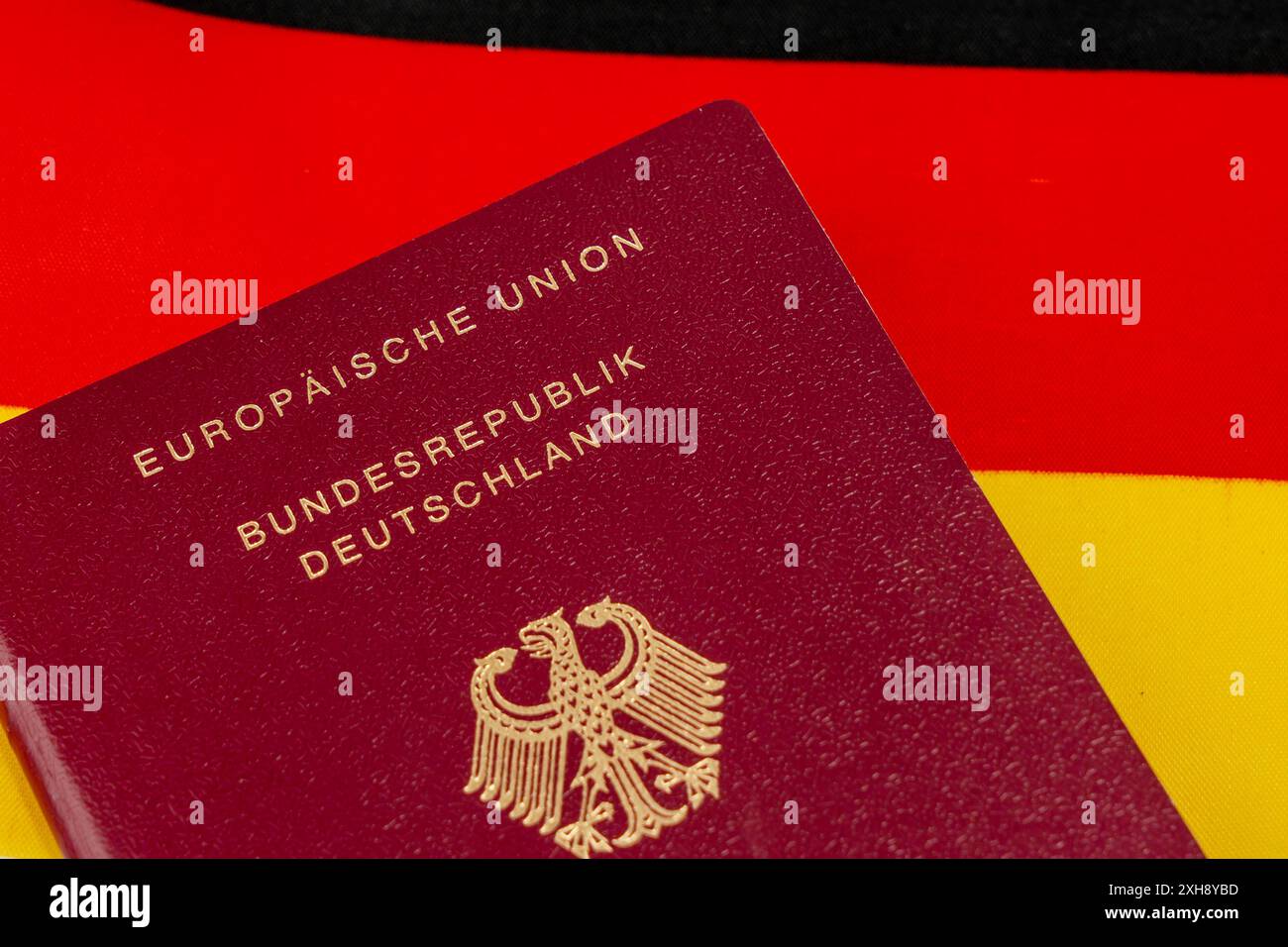 Red passport of a German citizen. The passport is placed on top of the ...