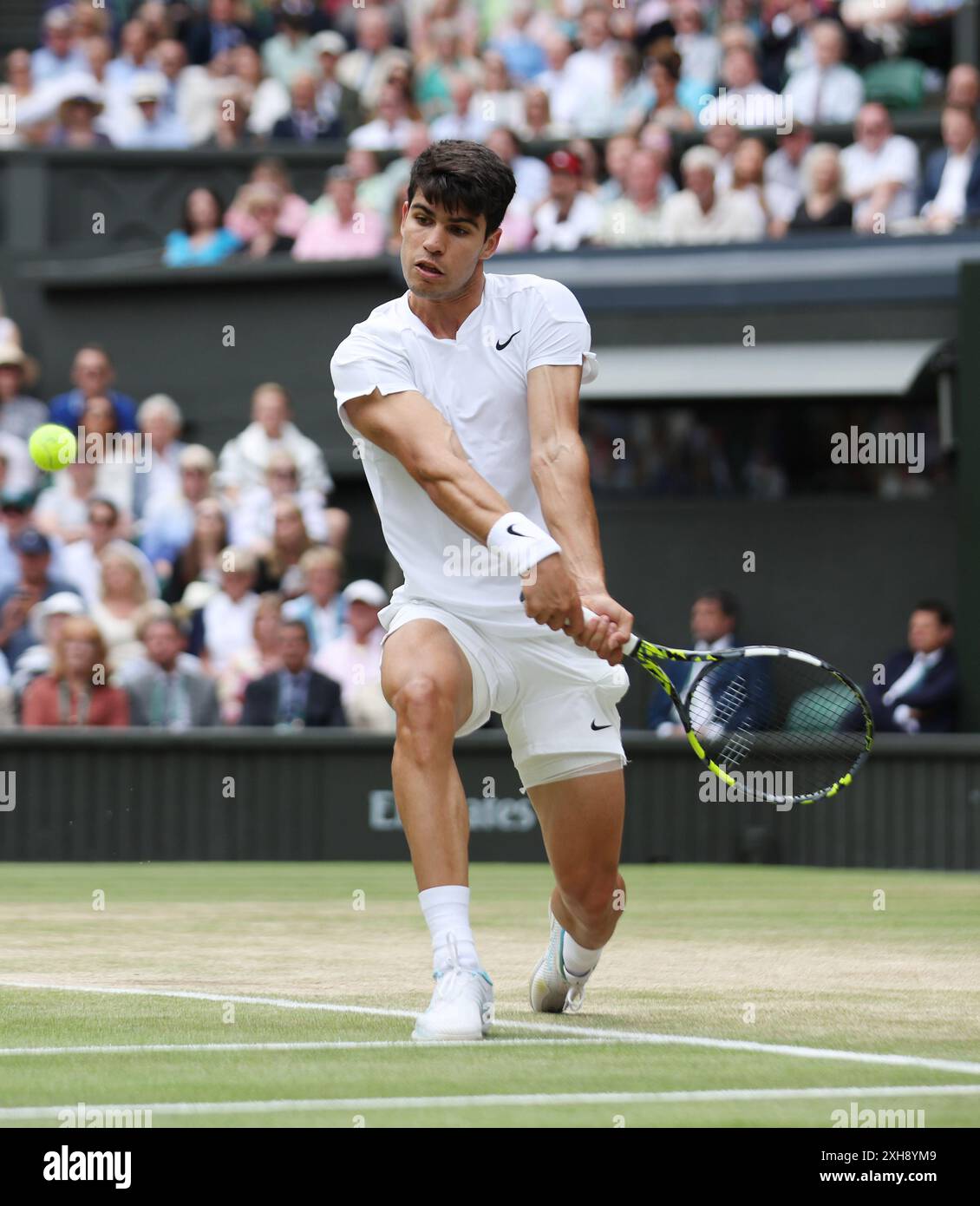 London, UK. 12th July, 2024. Carlos Alcaraz plays a forehand in his Men ...