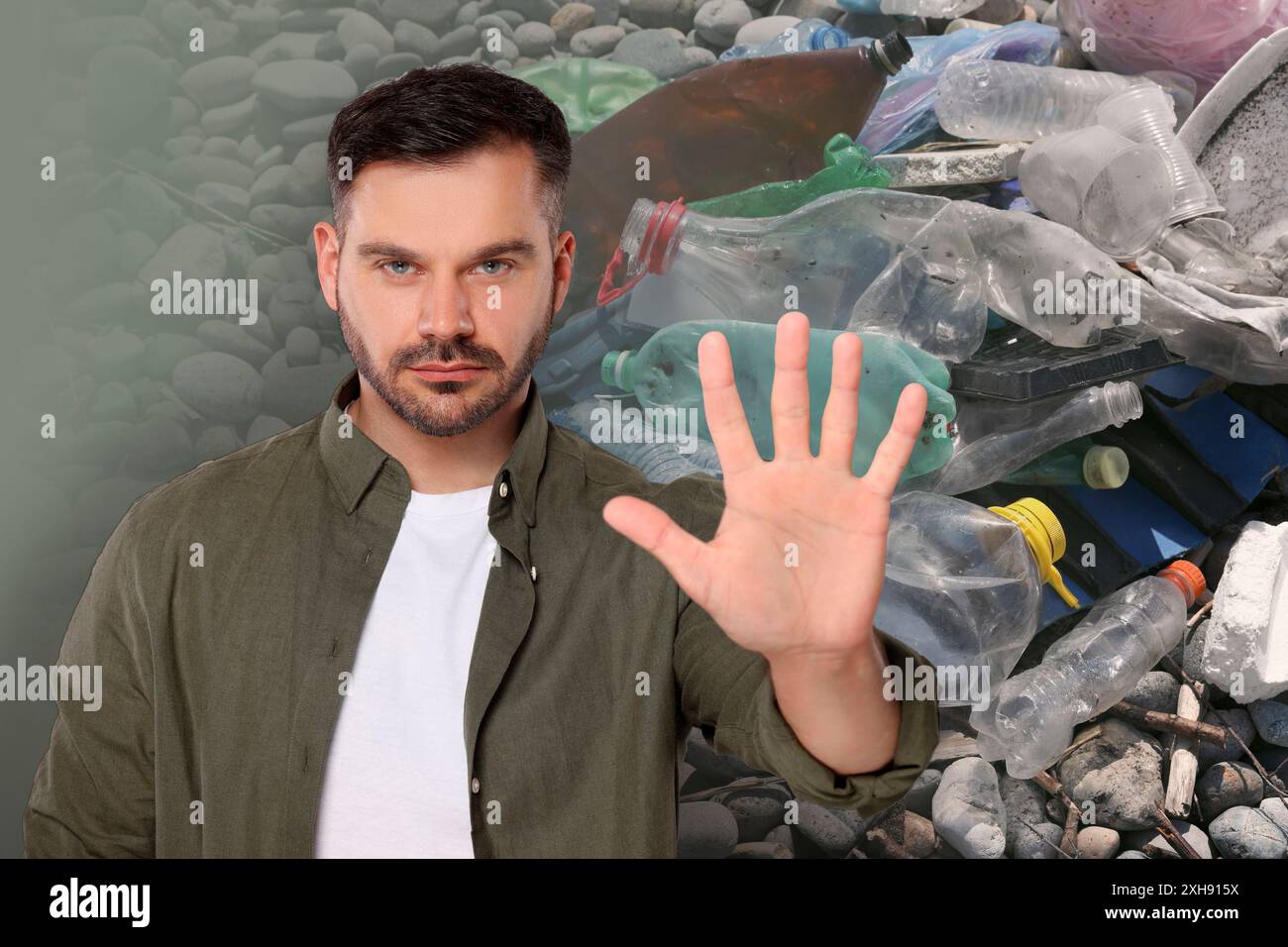 Environmental pollution. Man showing stop gesture among garbage on ...