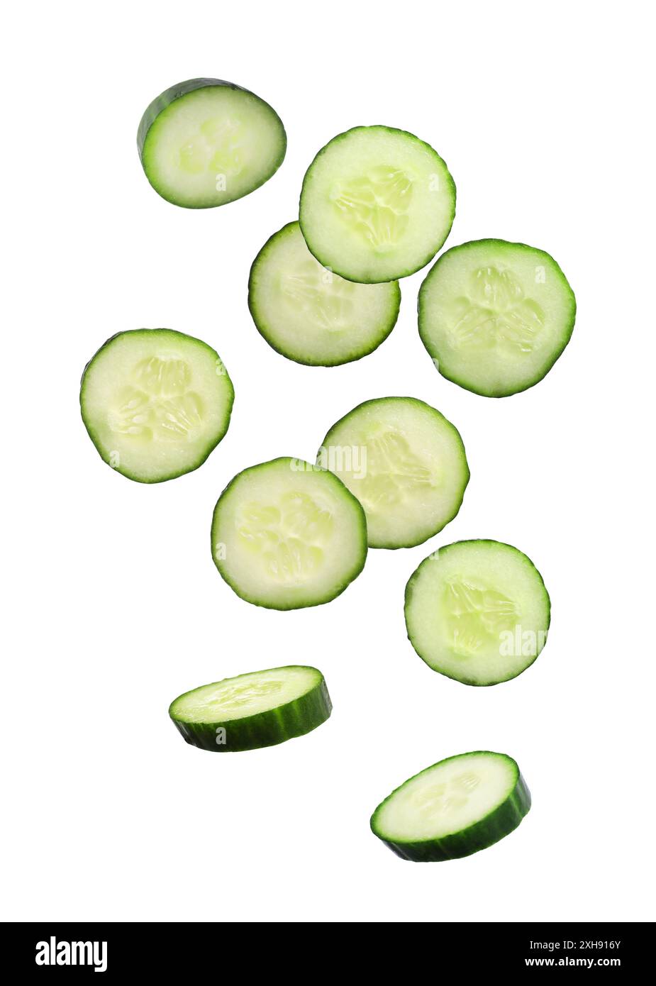 Fresh cucumber slices in air on white background Stock Photo - Alamy