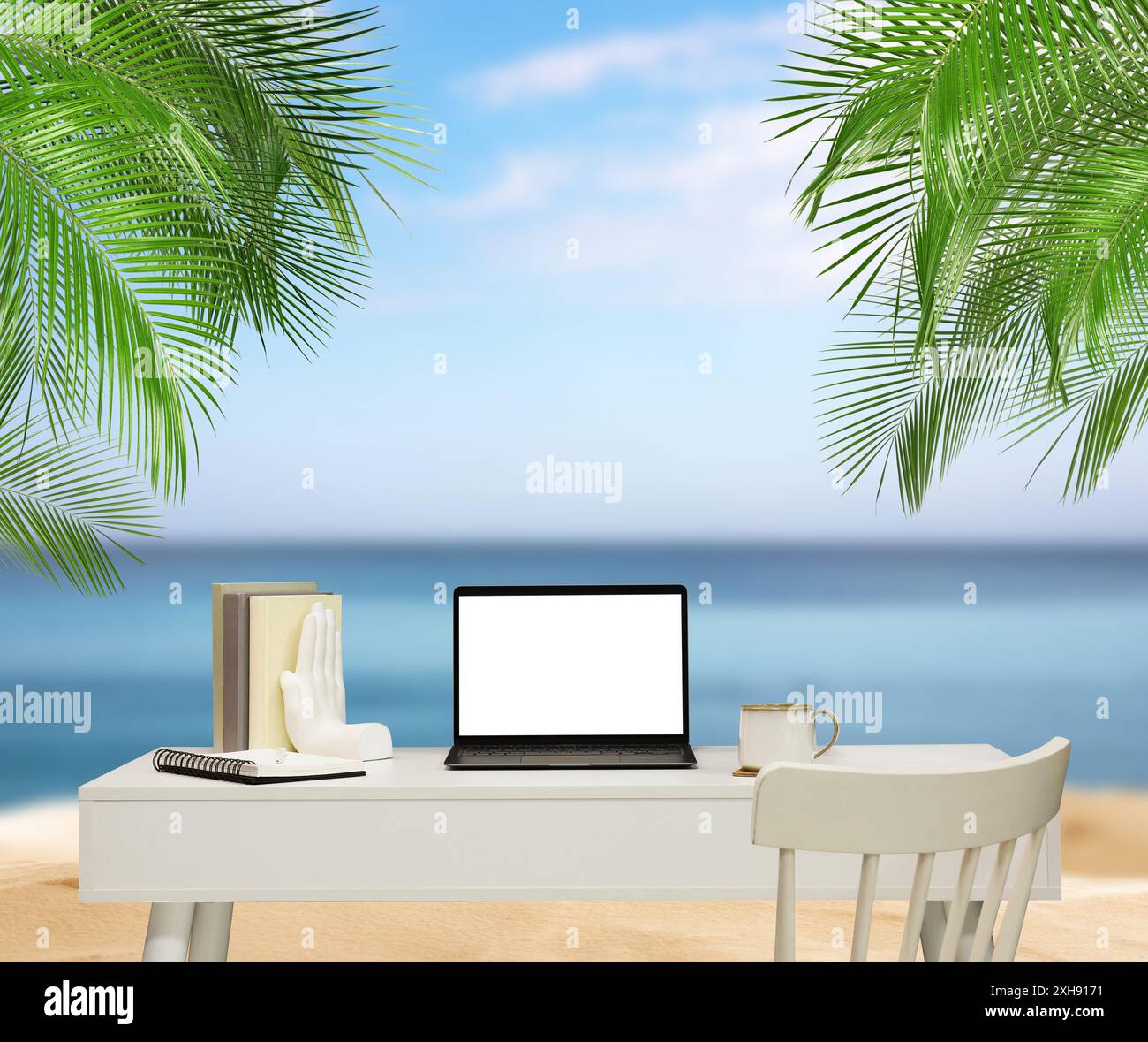 Workplace at beach, distant office. Table with laptop and chair on ...