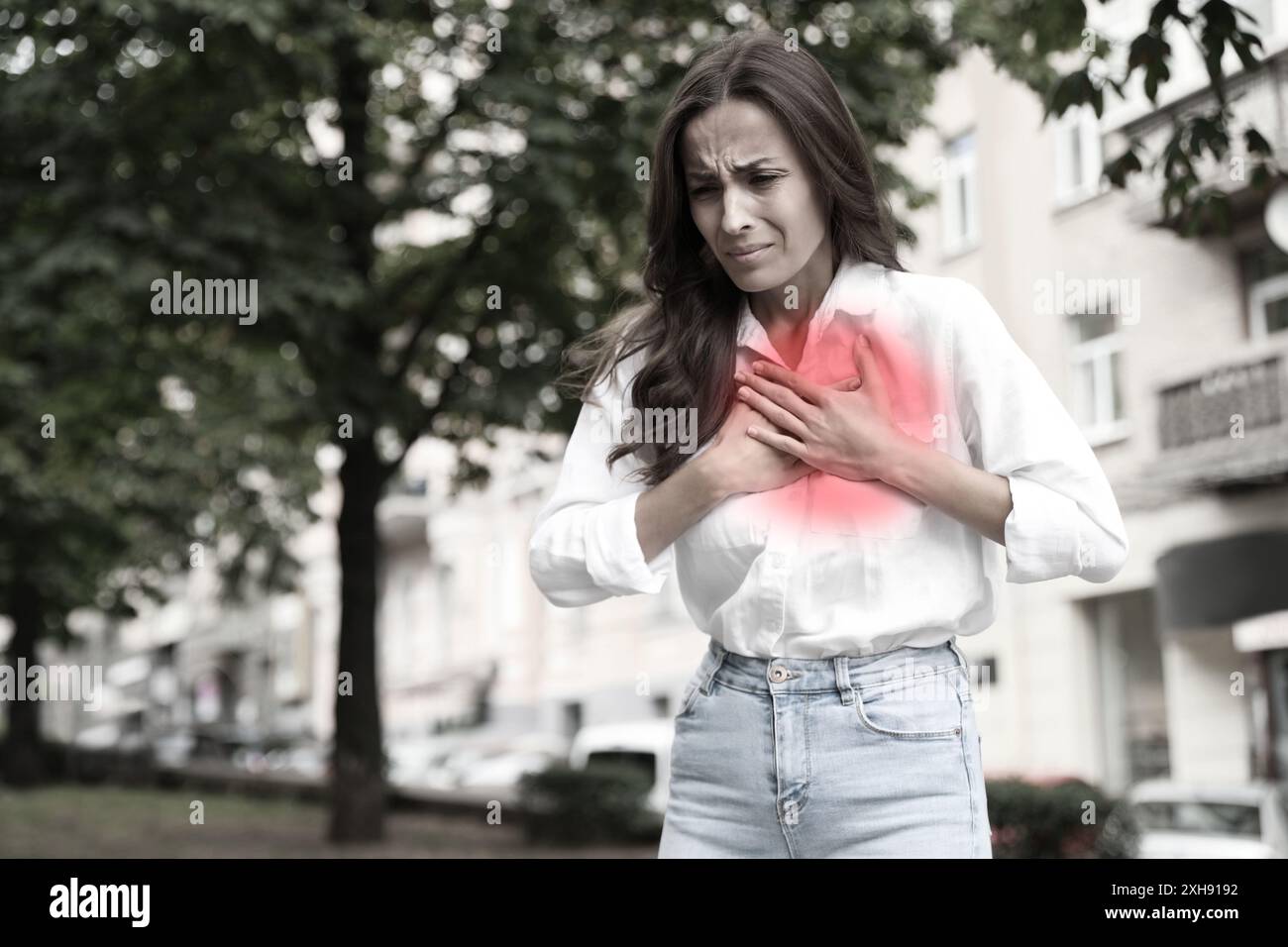 Heart attack. Woman suffering from pain and pressing hands to chest ...