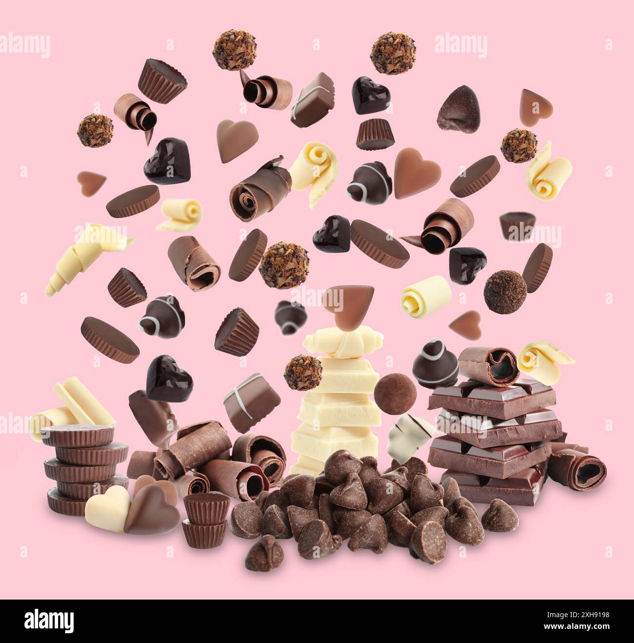 Sweet chocolate candies falling on pink background Stock Photo - Alamy