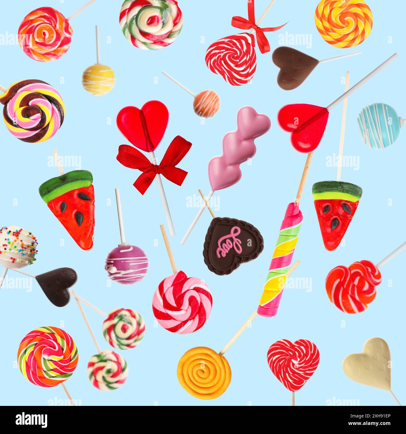 Different sweets in air on light blue background Stock Photo - Alamy