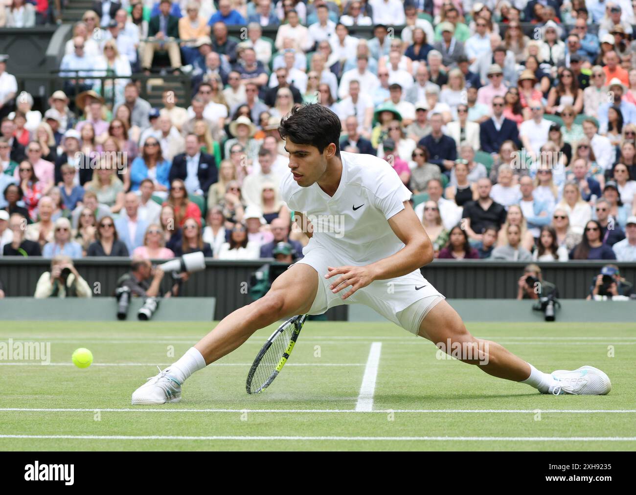 London, UK. 12th July, 2024. Carlos Alcaraz plays a backhand in his Men ...