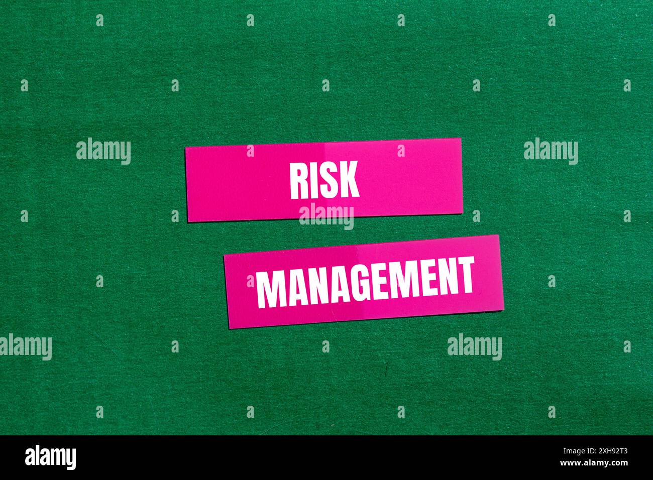 Risk management message written on pink paper with green background ...