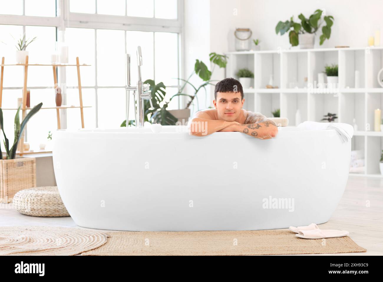 Handsome man taking bath at home Stock Photo - Alamy