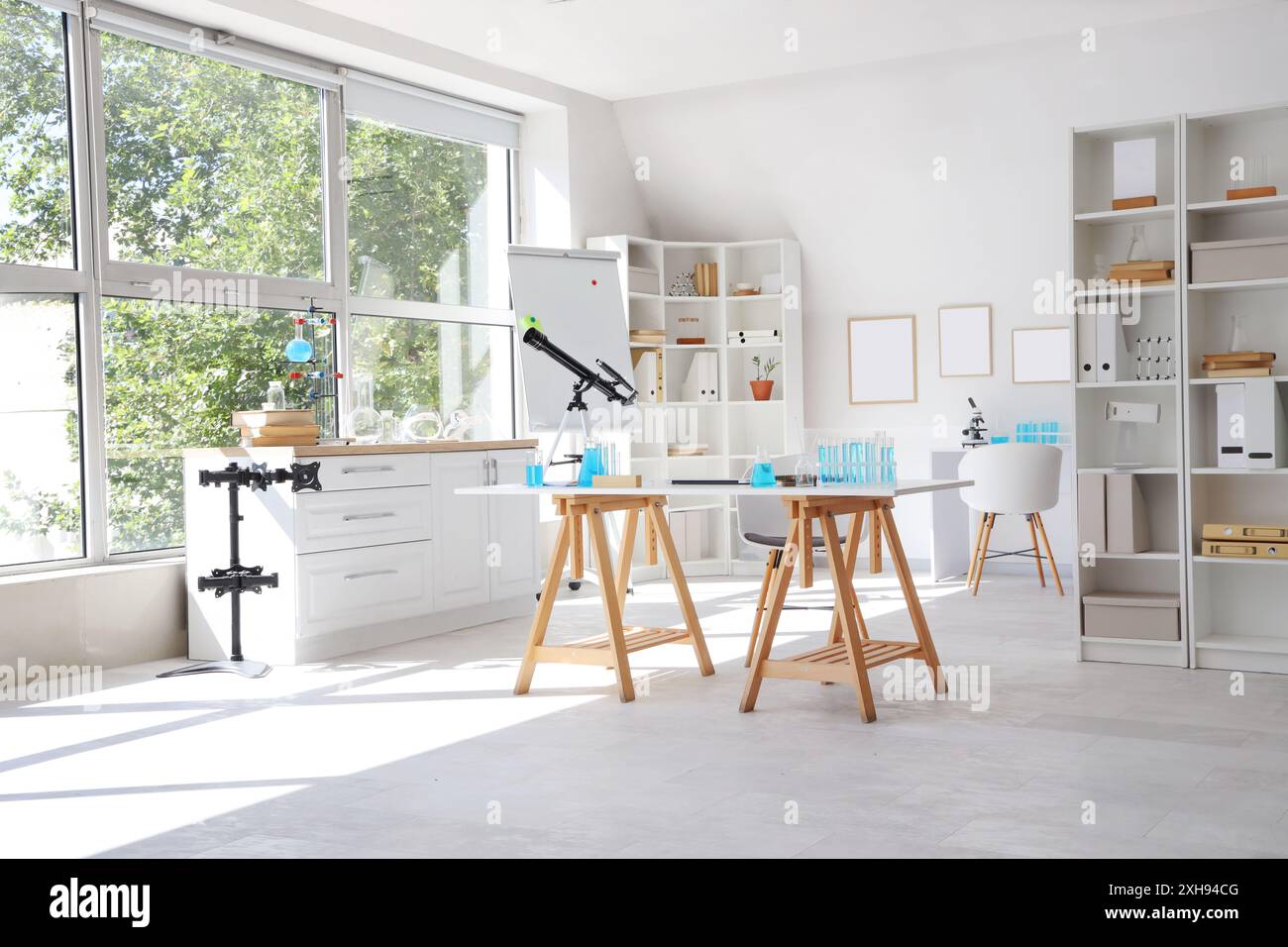 Interior of laboratory with tables, shelf units and chemical equipment ...