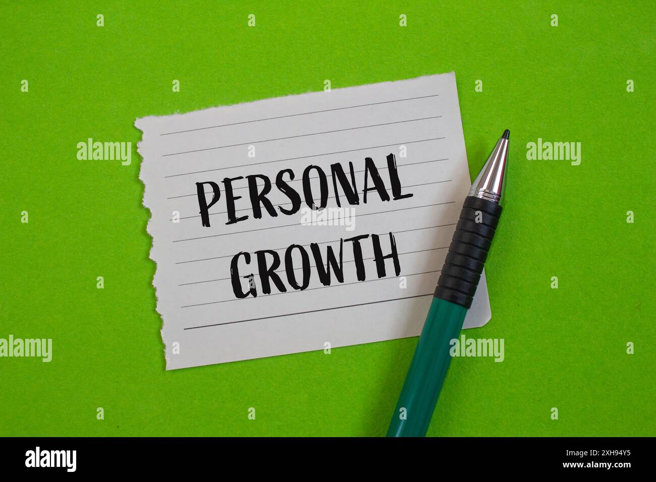 Personal growth message written on ripped paper piece with ...