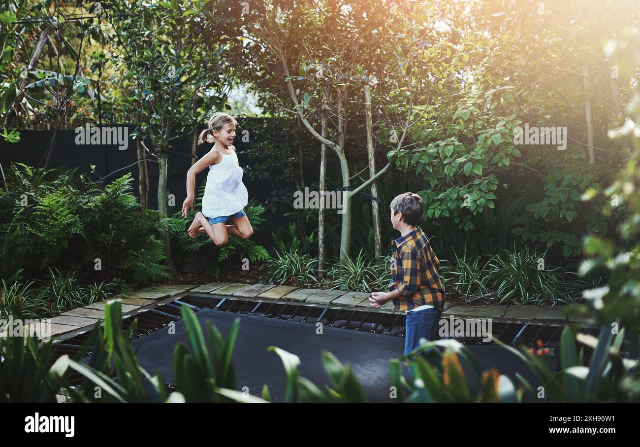 Nature, jumping and children on trampoline in backyard for fun, hobby ...