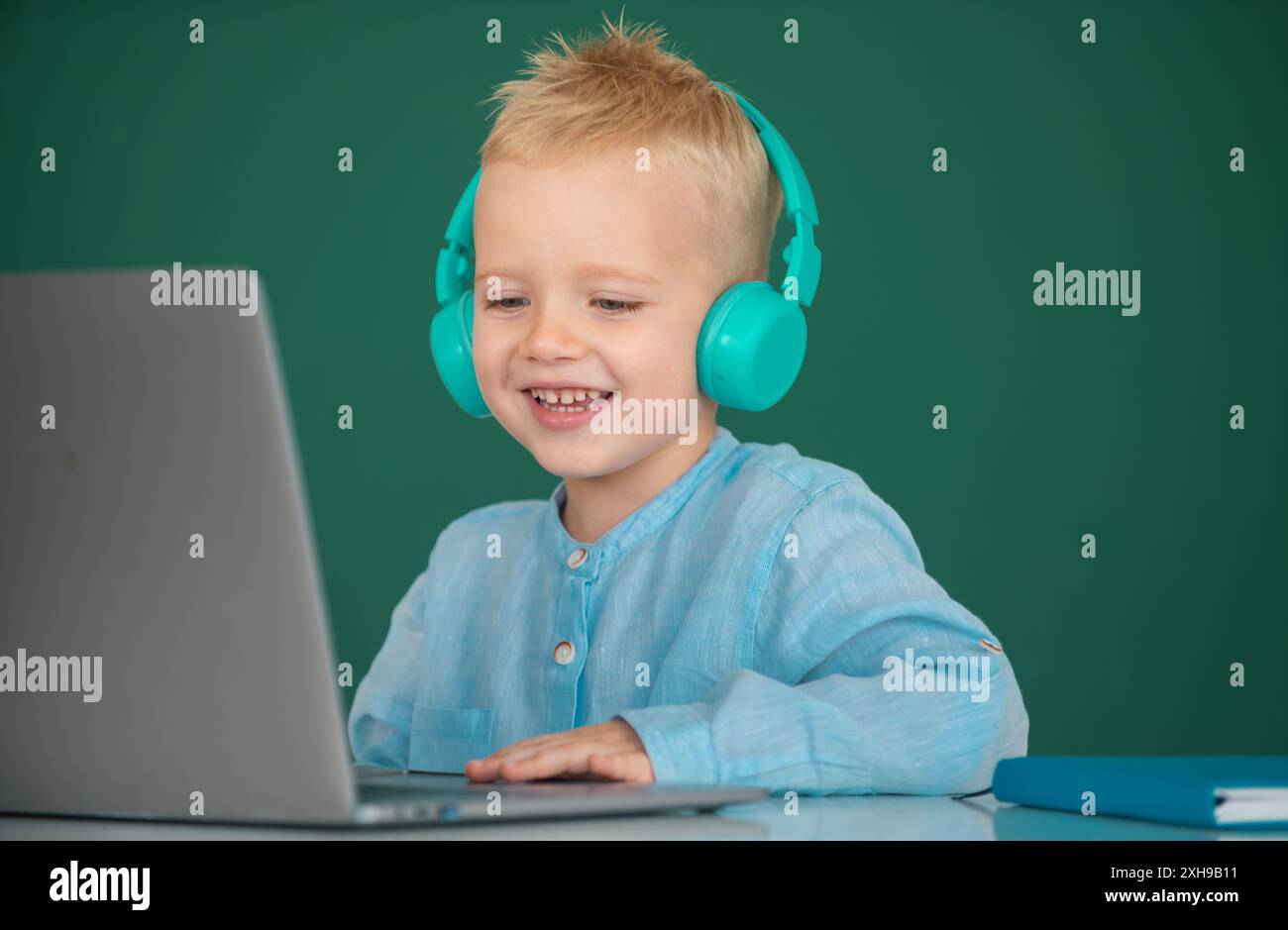 Cute little child using laptop computer, kid boy studying through ...