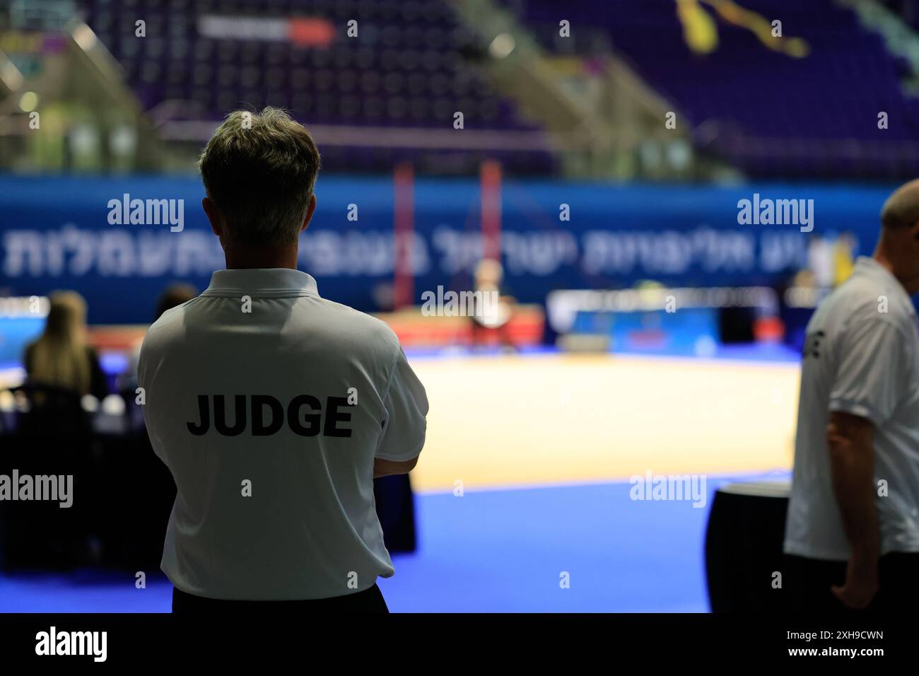 The judge is carefully observing a gymnastics tournament taking place ...