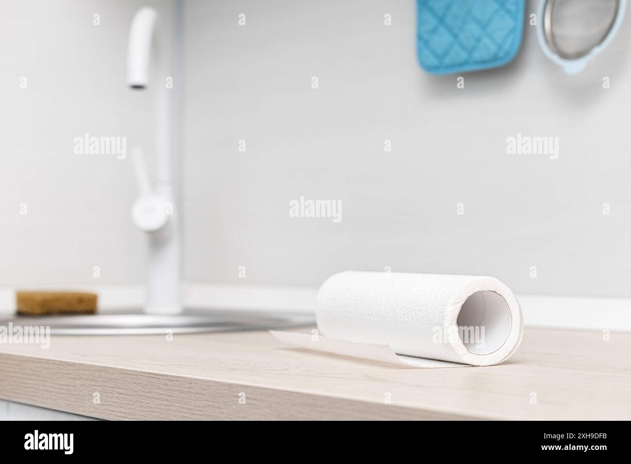 a roll of paper towel lies on the kitchen counter. leftover paper towel ...