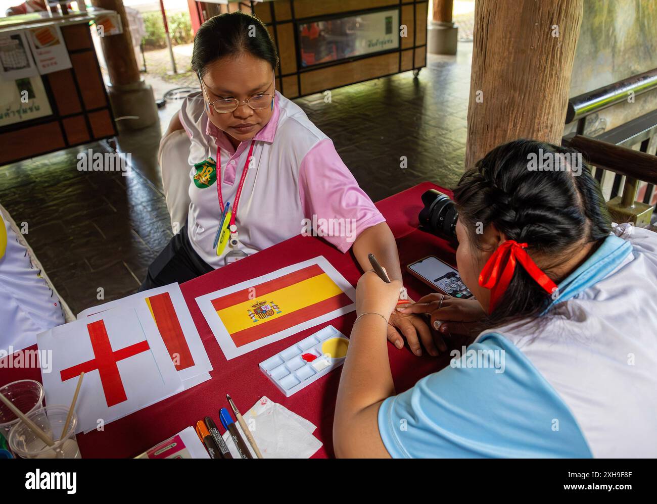A Thai staff member of the Chiang Mai Night Safari, is being painted ...