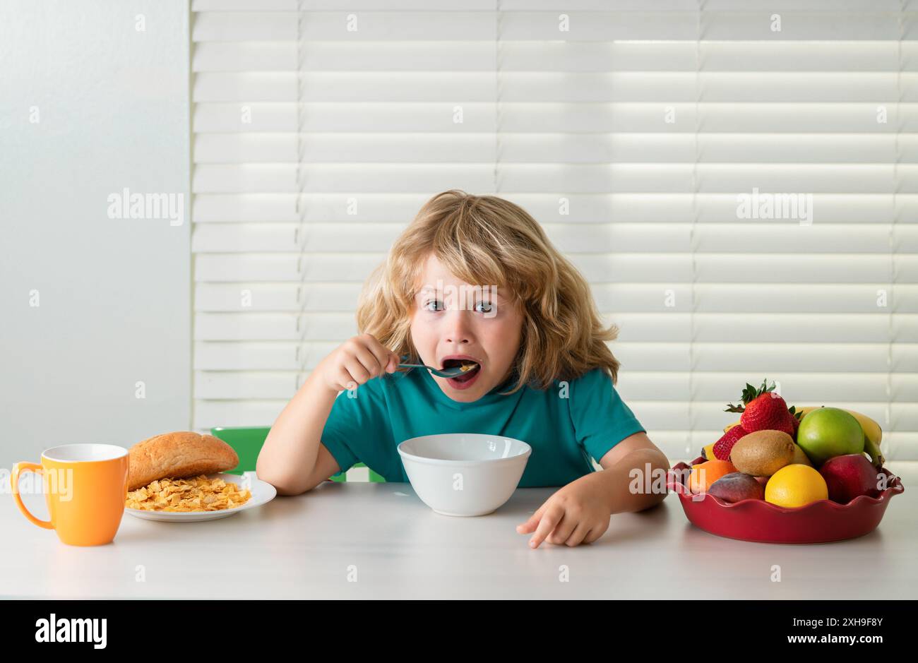 Little child boy having healthy breakfast. Kids nutrition and ...