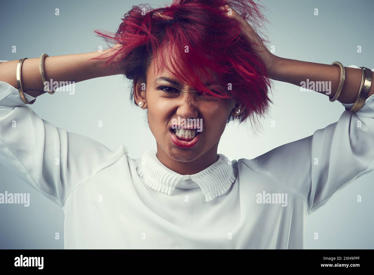 Anger, frustrated and girl in studio holding head for trauma, mental ...