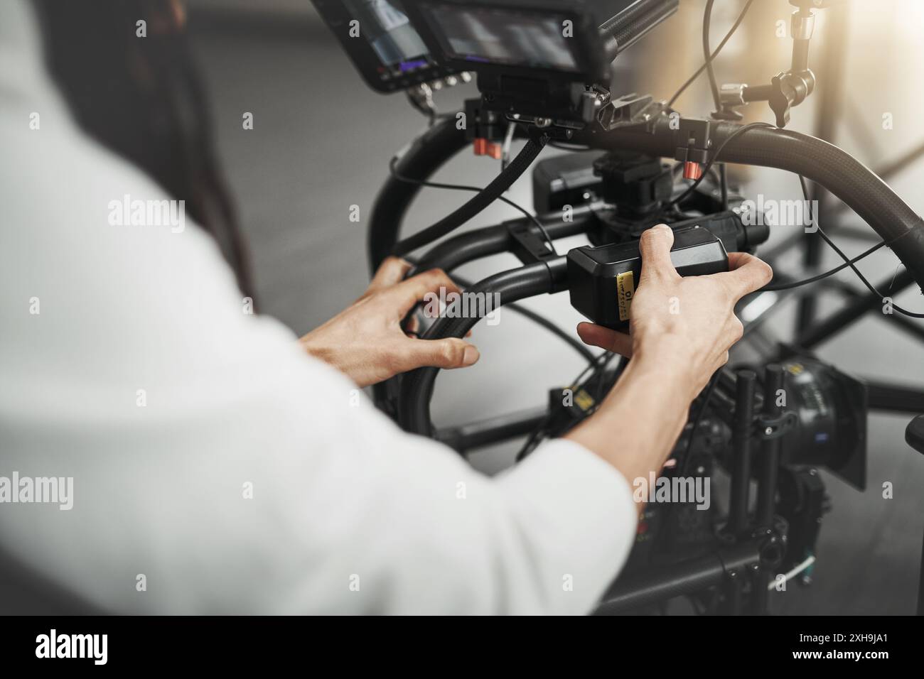 Photographer, camera and focus with stabilizing equipment on set for ...