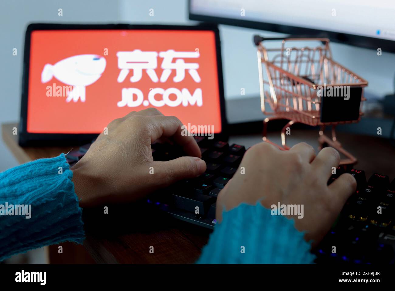 In this photo illustration, a person types next to the JD.com, Inc ...