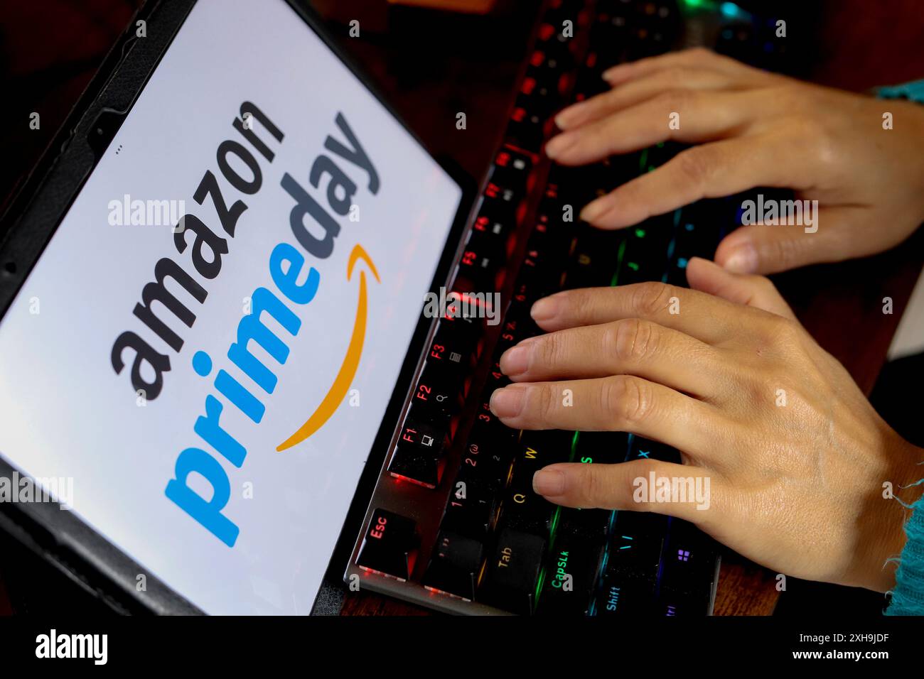 In this photo illustration, a person types next to the Amazon Prime Day ...