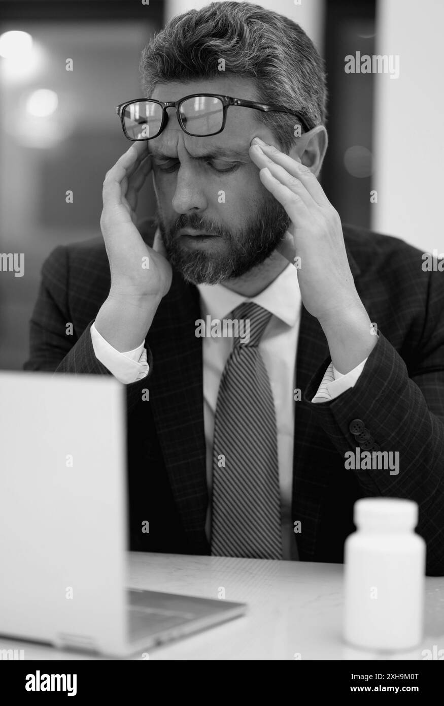 Headache and eye strain on laptop. Business man with stress and fatigue ...