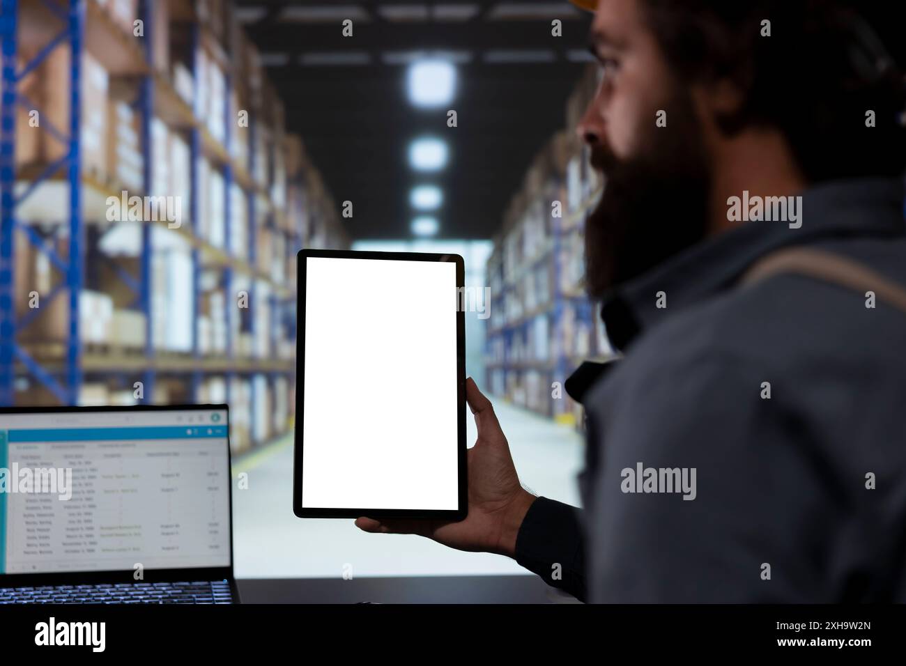Delivery supervisor looking at tablet with white screen layout ...