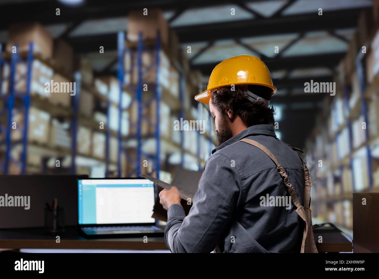 Production supervisor dealing with inventory management in depot ...