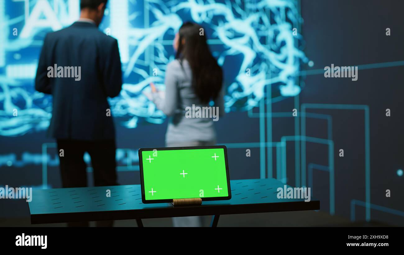 AI programmers colleagues using green screen laptop for business data analysis. IT experts in ...