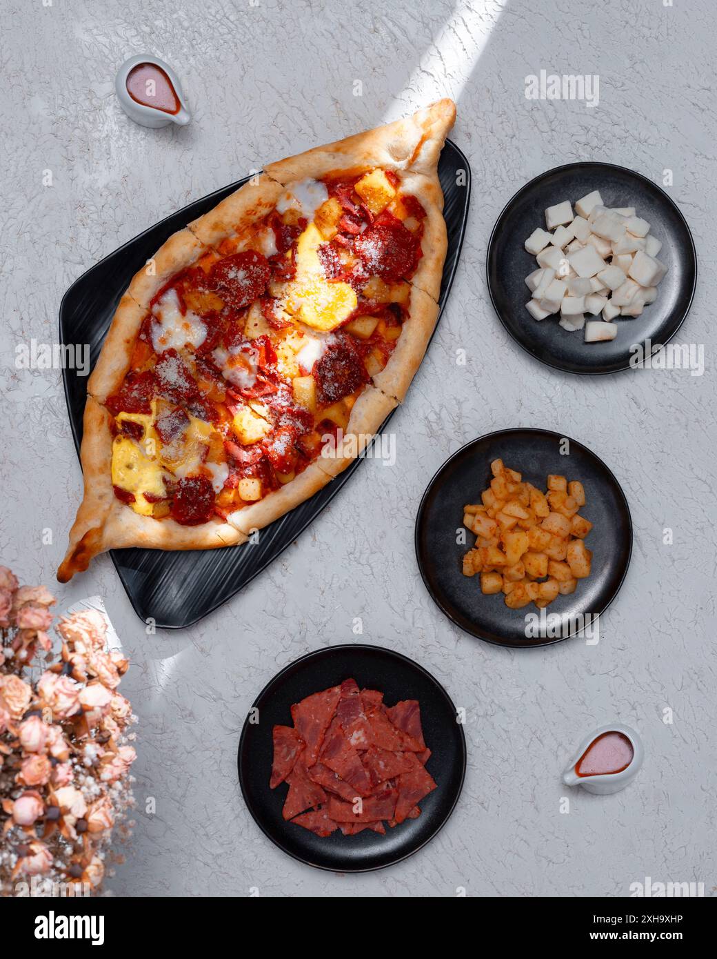 Turkish pide with various toppings on a rustic background Stock Photo ...
