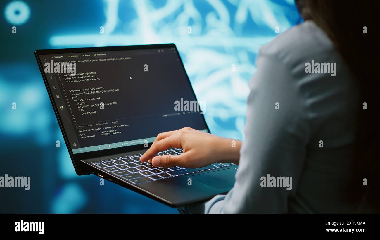 Engineer using notebook to maintenance artificial intelligence neural networks. Close up shot of ...
