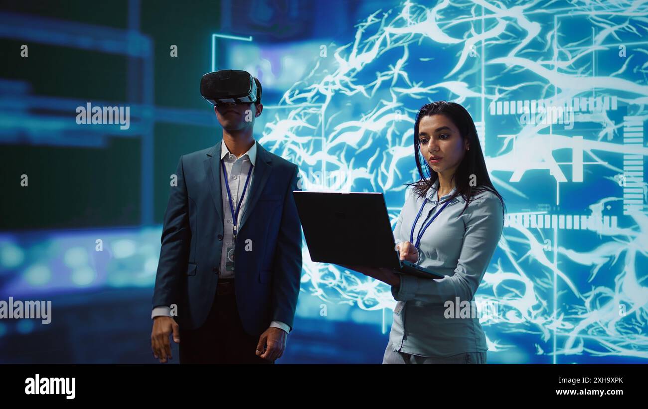 Technician wearing VR headset looks at hologram of artificial ...