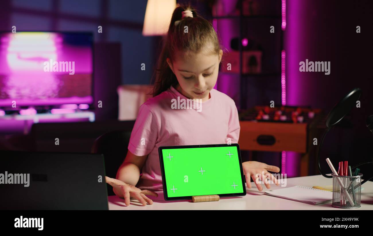 Cute child content creator filming technology review of newly released ...