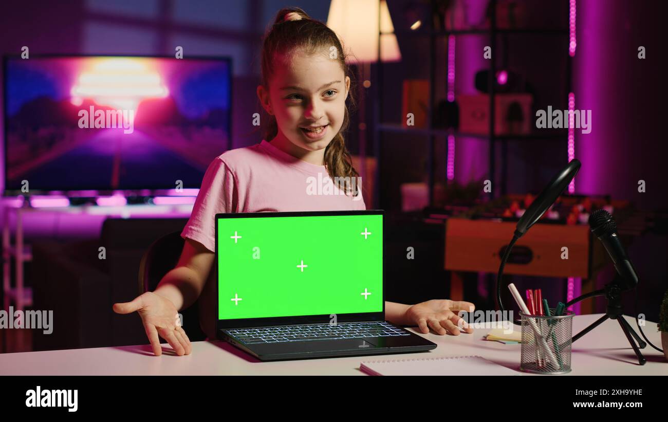 Child tech content creator filming technology review of green screen ...
