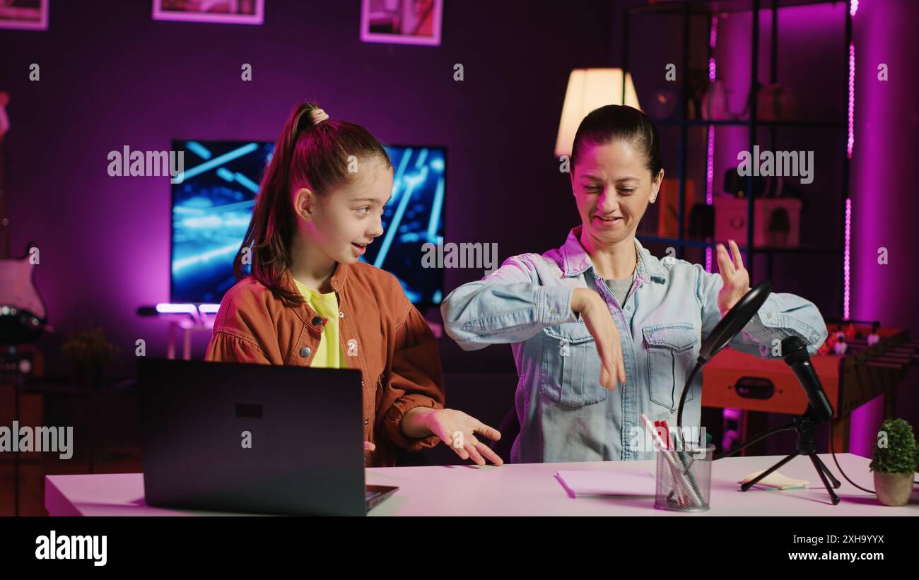 Young girl teaching her mother how to do viral online dance moves while ...