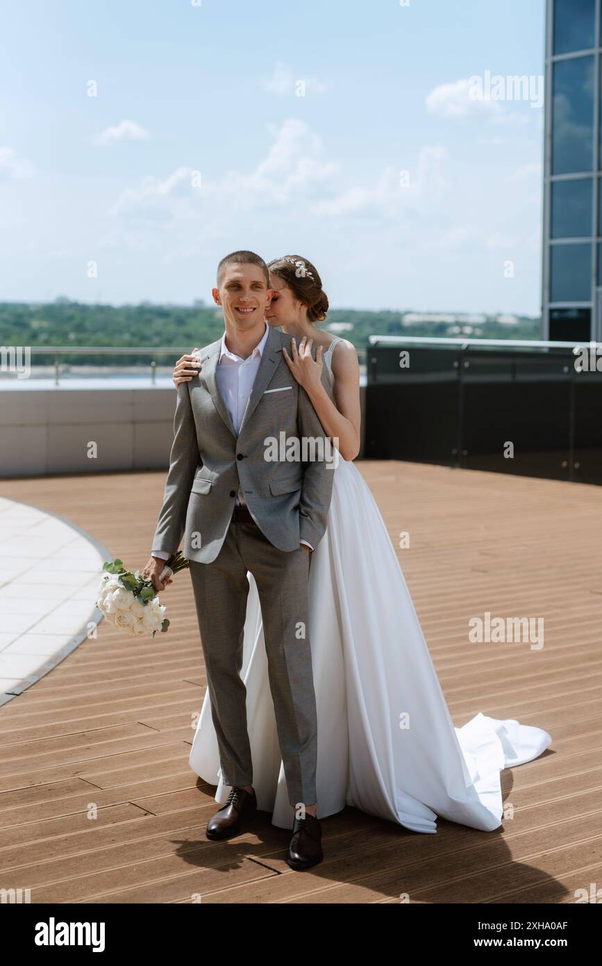 bride and groom first meeting on the roof of a glass skyscraper Stock ...