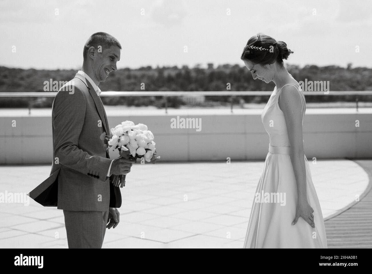 bride and groom first meeting on the roof of a glass skyscraper Stock ...
