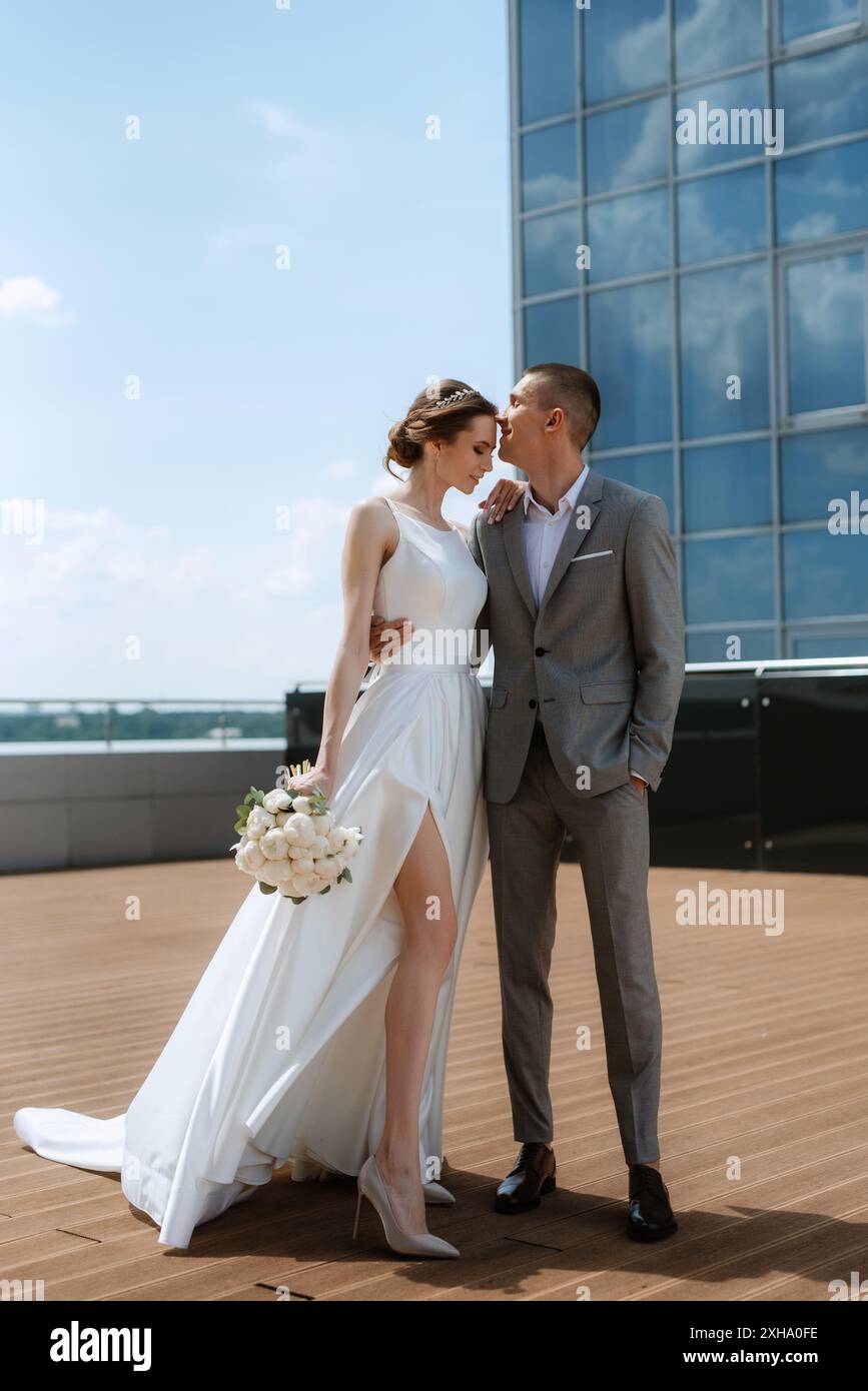 bride and groom first meeting on the roof of a glass skyscraper Stock ...