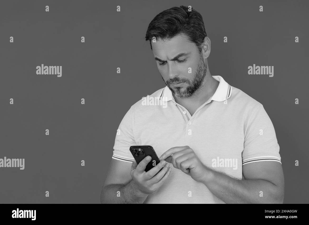 European business man watching on mobile phone. Handsome man wearing ...