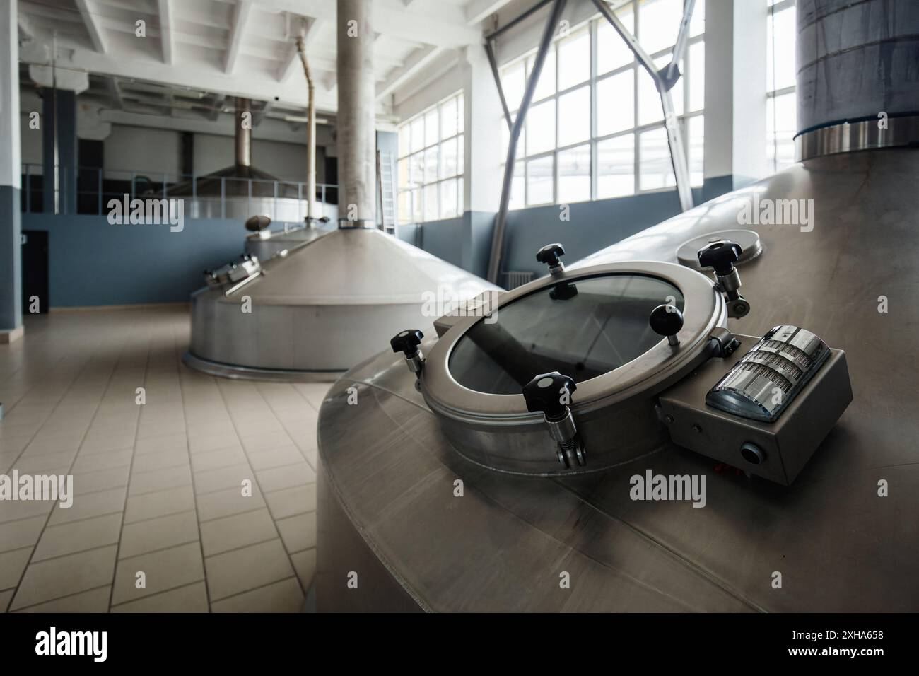 Looking glass of steel tank for beer fermentation in modern brewery ...