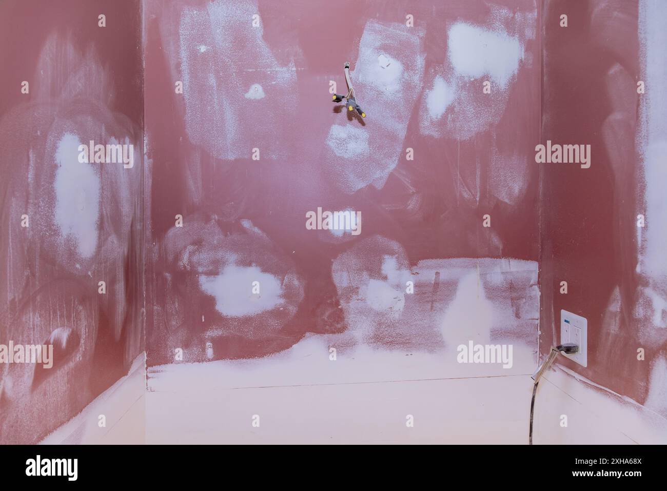 Repairing damaged walls in home by putting tying them Stock Photo - Alamy