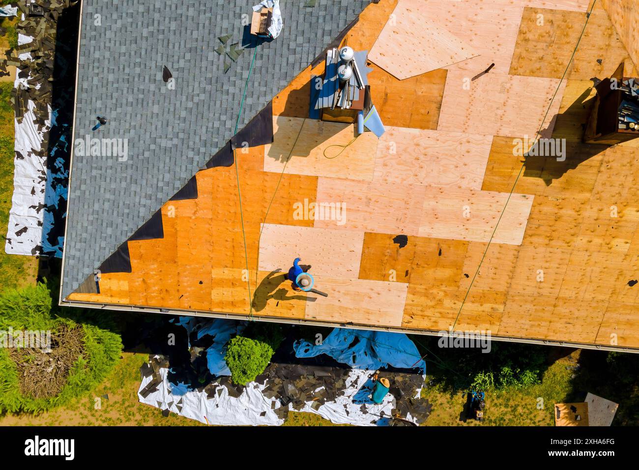 Roof repair by replacing old asphalt bitumen shingles Stock Photo - Alamy