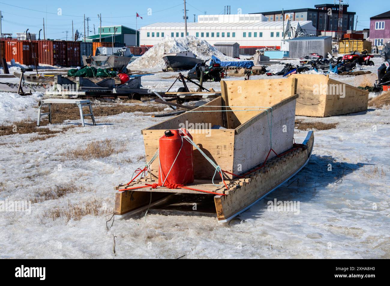 Inuit qamutiik wooden sleds stored on the beach on Frobisher Bay in Iqaluit, Nunavut, Canada ...