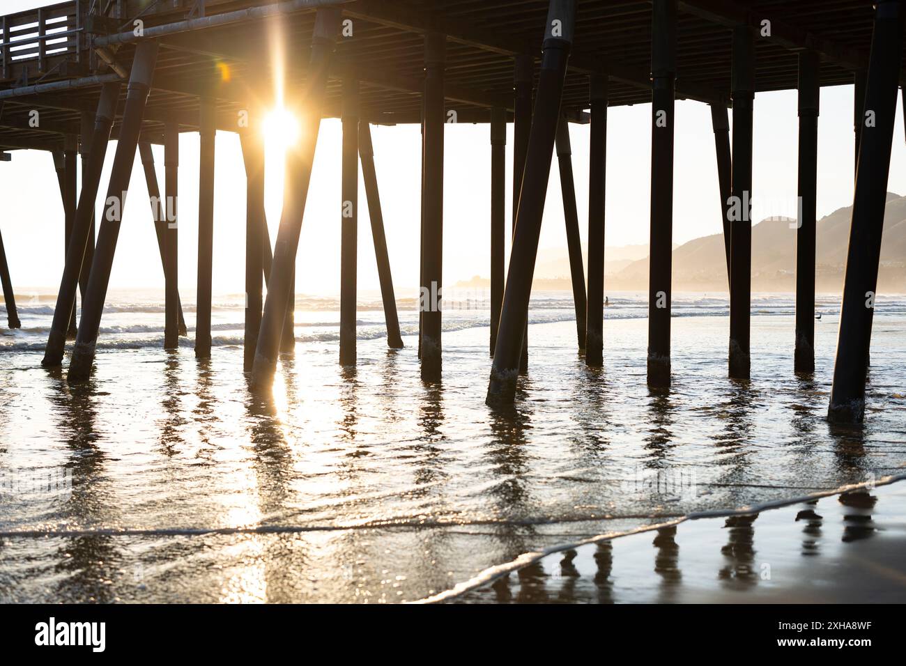 Sunset beach pier surfer hi-res stock photography and images - Alamy