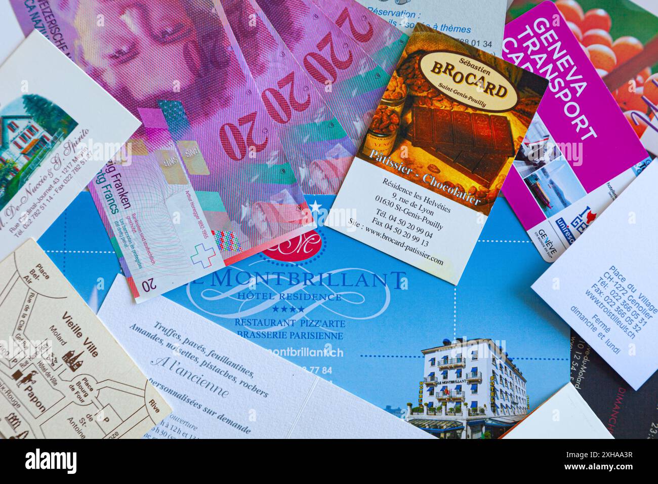 Travel brochures and money for the Geneva region of Switzerland Stock ...