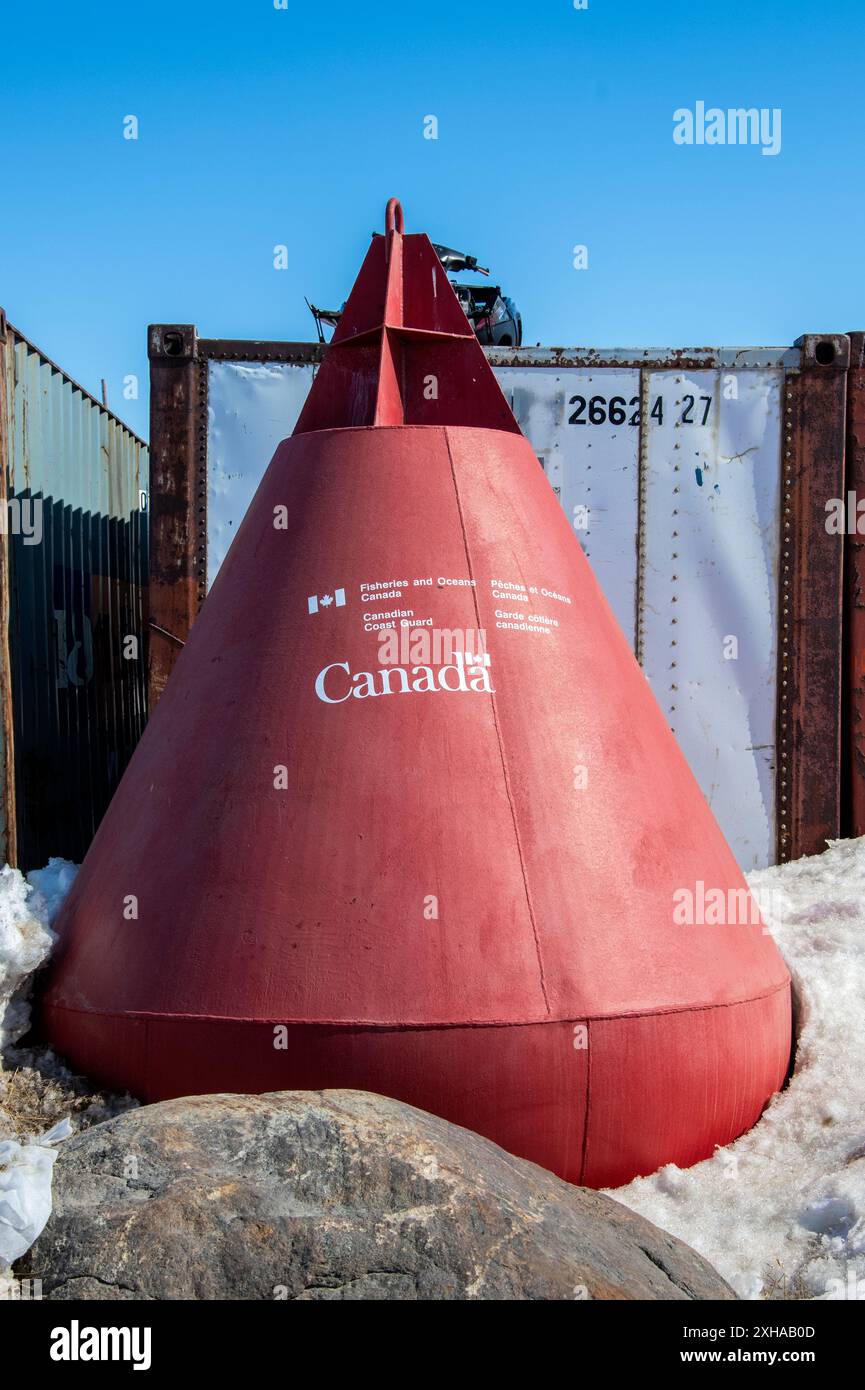 Red starboard marker buoy on the beach on Frobisher Bay in Iqaluit ...